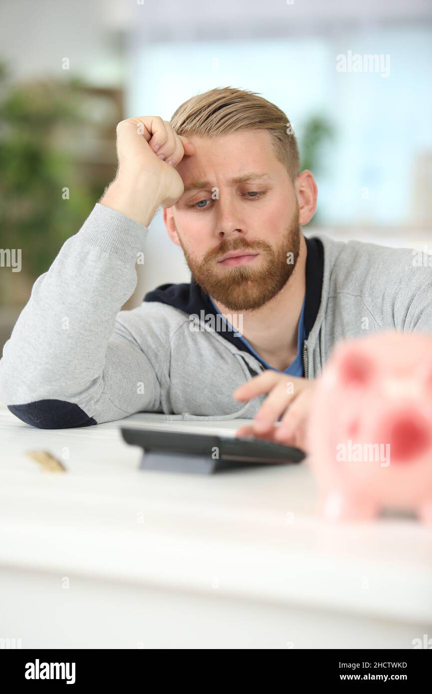 frustrated businessman calculates the cost Stock Photo - Alamy
