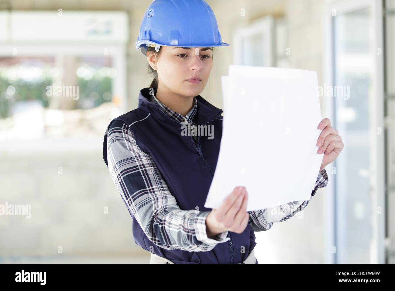 architect woman holding building blueprints Stock Photo - Alamy