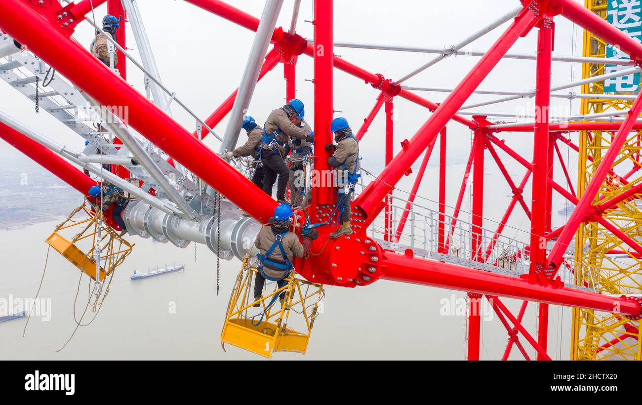 WUXI, CHINA - JANUARY 1, 2022 - Construction workers assemble the world's tallest power ...