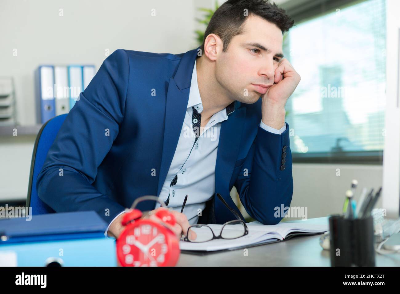 bored male executive at office desk Stock Photo - Alamy