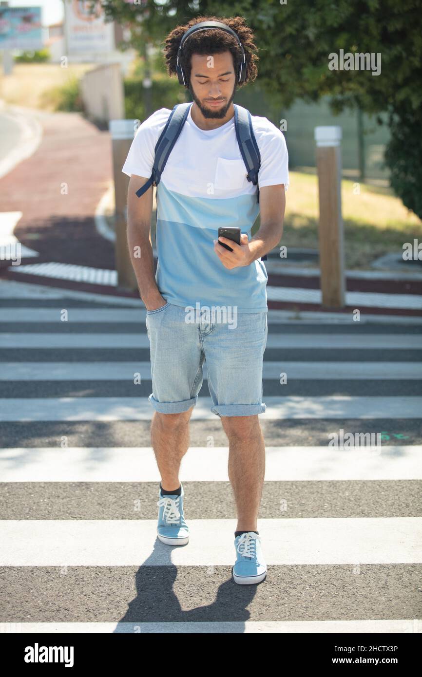 young handsome afro black man standing on the sidewalk Stock Photo - Alamy