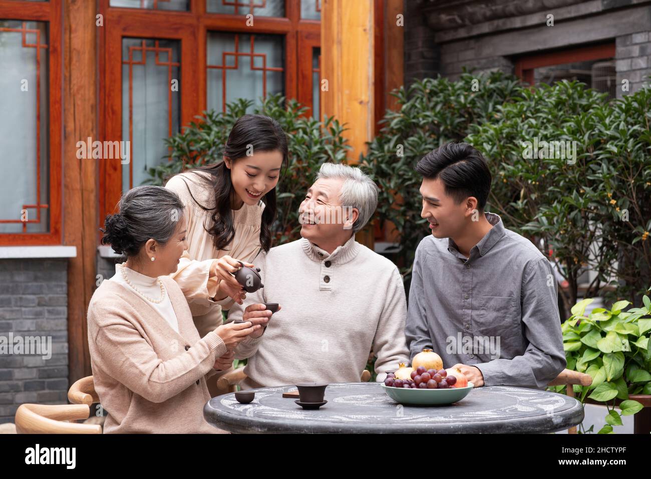 Happy families drinking tea and chatting in the courtyard Stock Photo ...