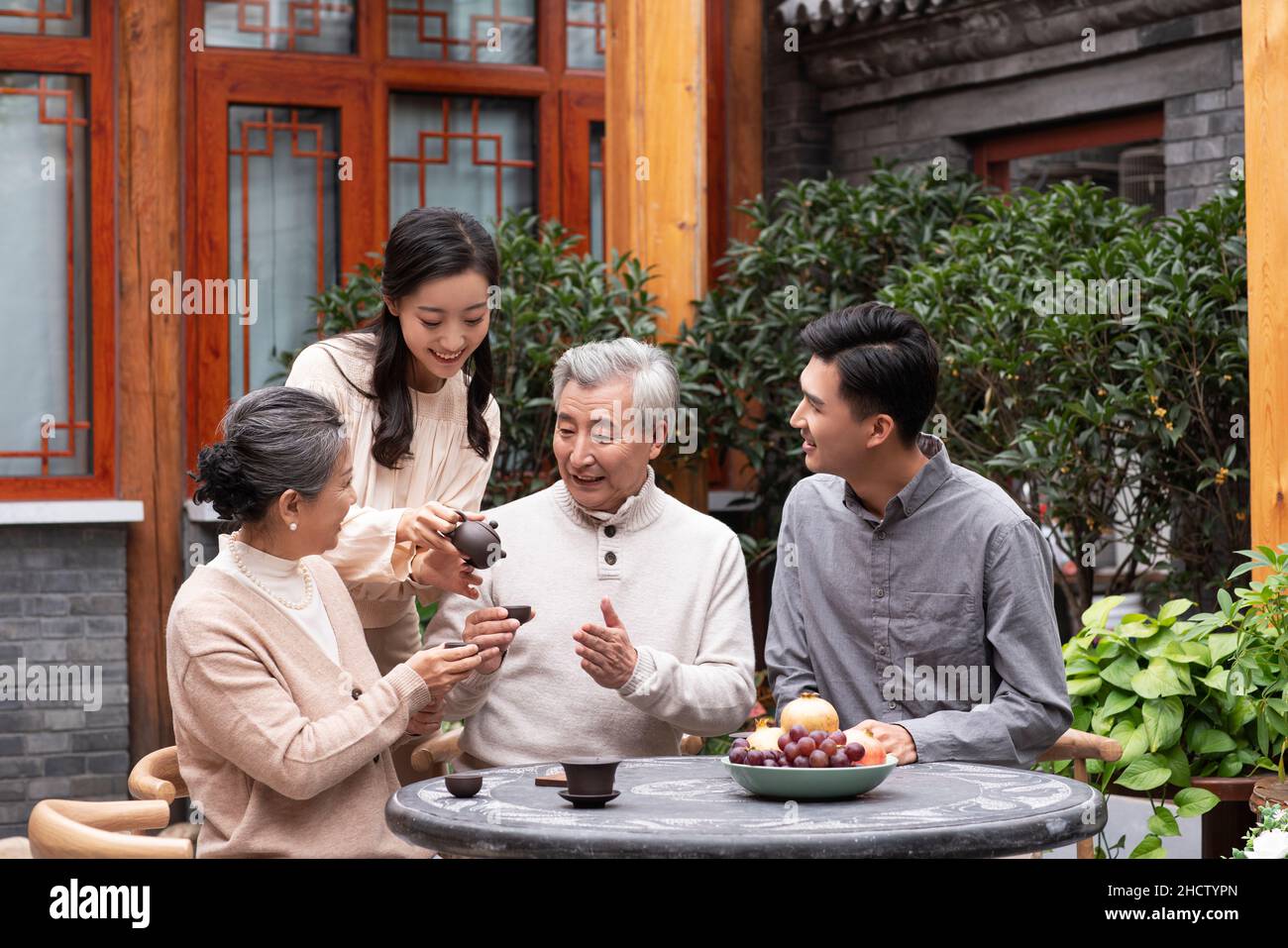 Happy families drinking tea and chatting in the courtyard Stock Photo ...