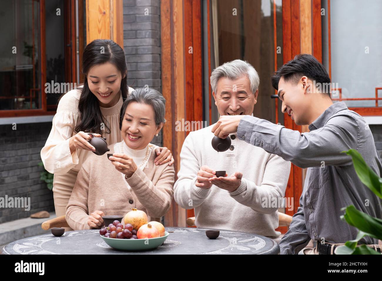 Happy families drinking tea and chatting in the courtyard Stock Photo ...