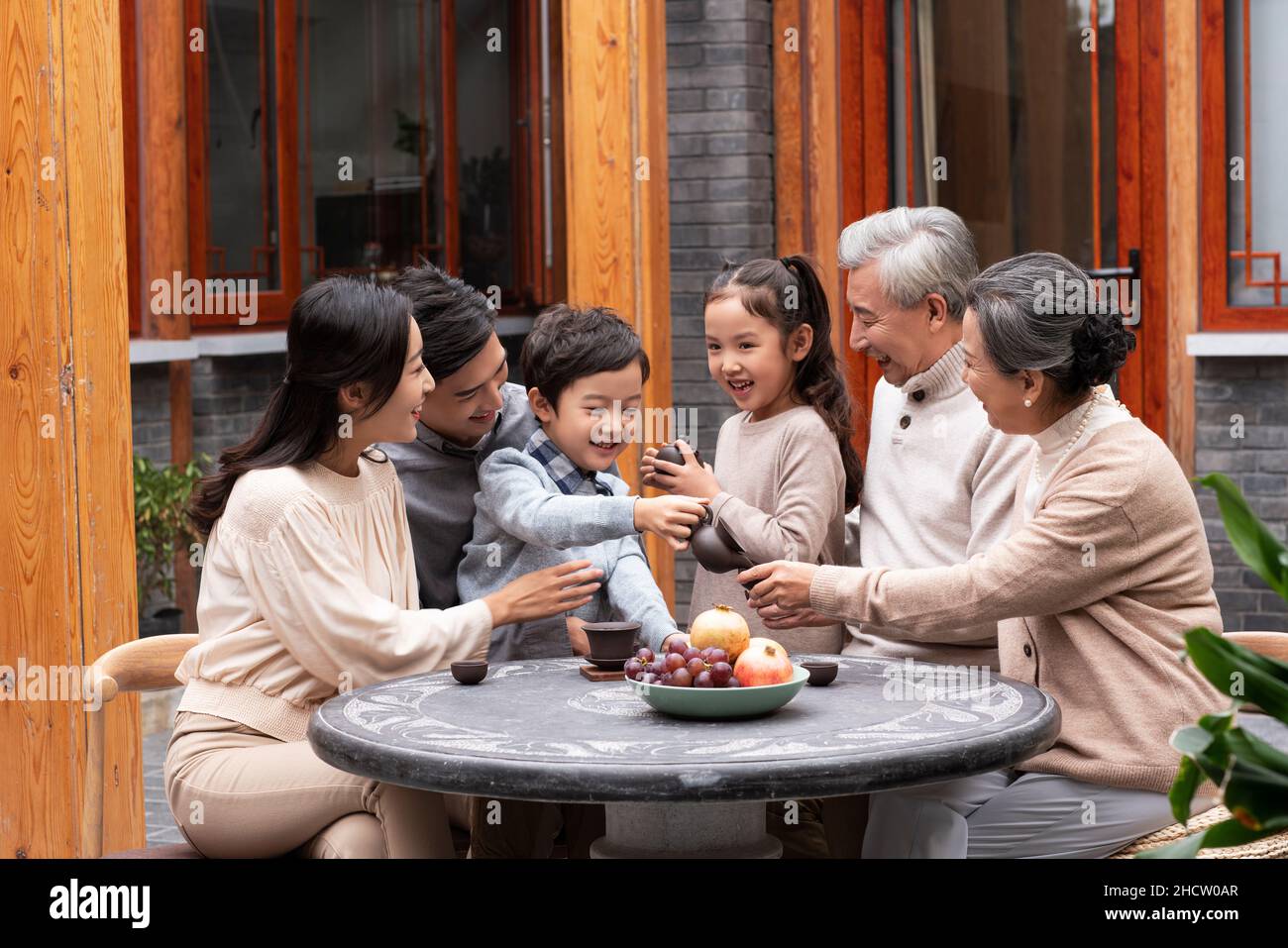 Happy families drinking tea and chatting in the courtyard Stock Photo ...