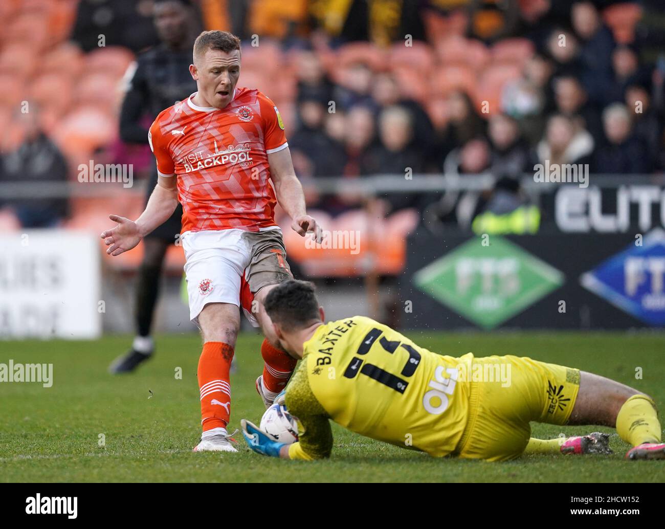Hull City goalkeeper Nathan Baxter saves at the feet of Blackpool's ...