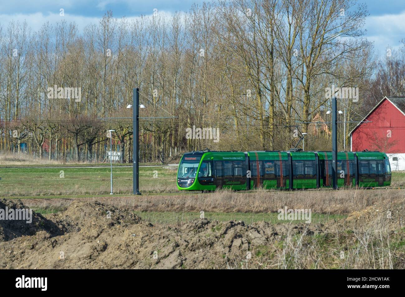 Lund, Sweden - April 10 2021: The new green electric tram moving in the ...
