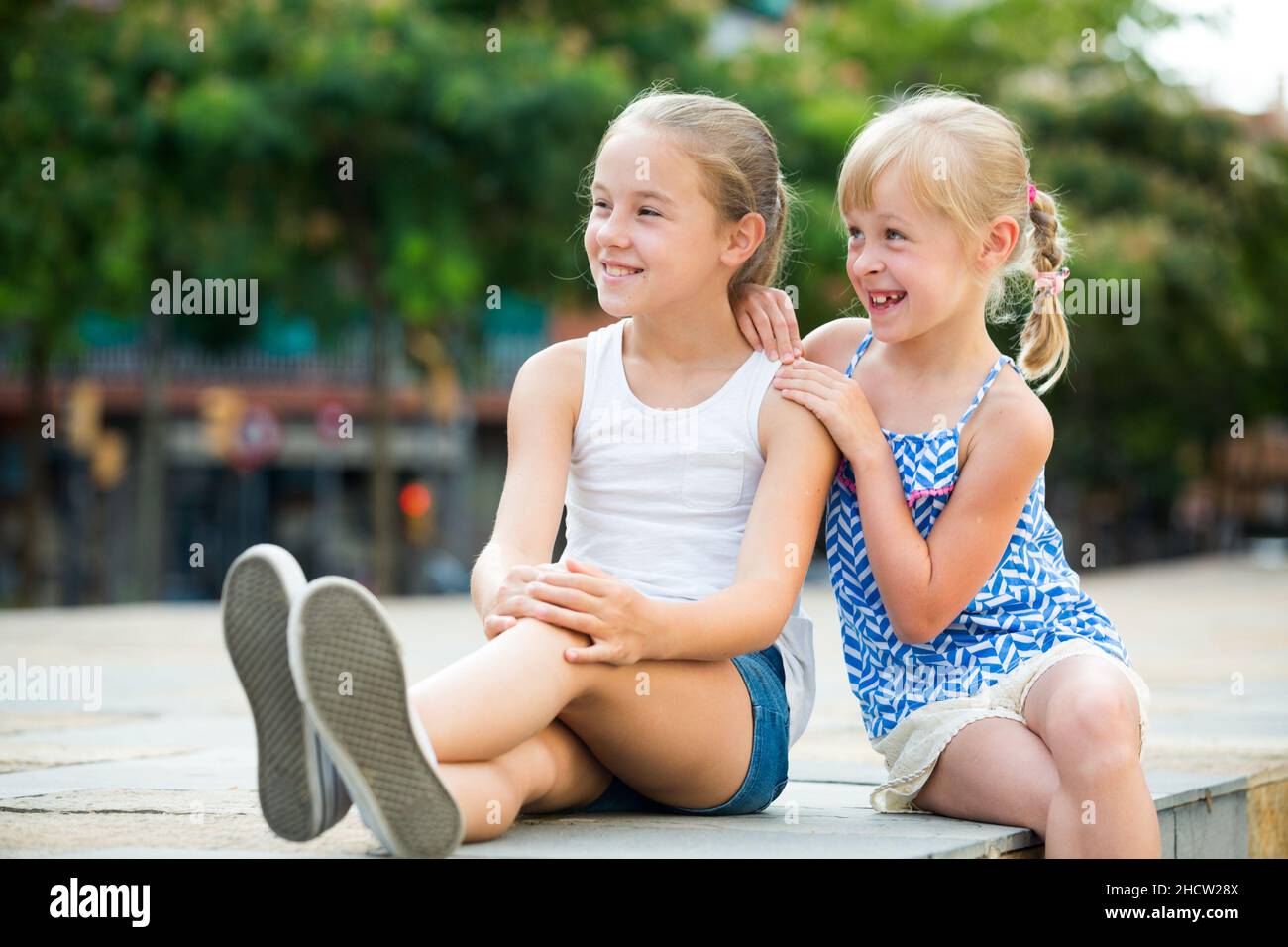 Two small sisters looking into distance Stock Photo - Alamy