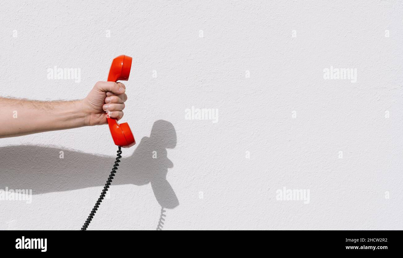 hand holding Red telephone receiver with copy space Stock Photo - Alamy