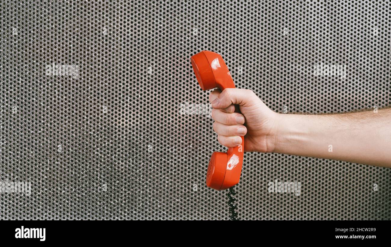 hand holding a red telephone receiver, office concept image Stock Photo ...