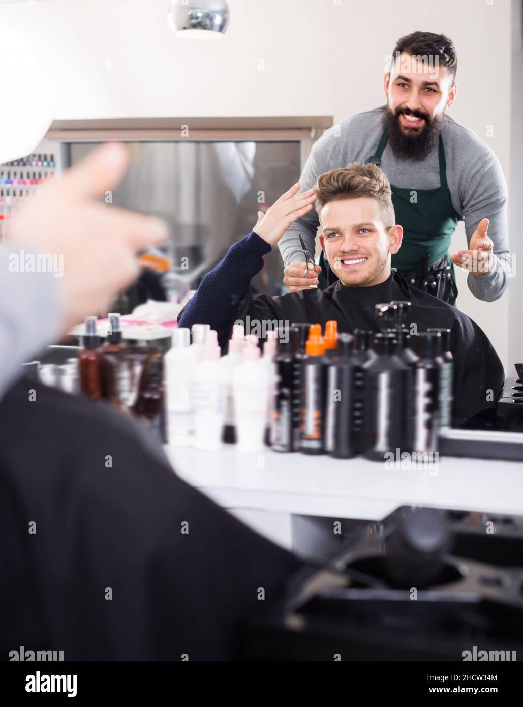 Young man client discussing his future haircut Stock Photo - Alamy