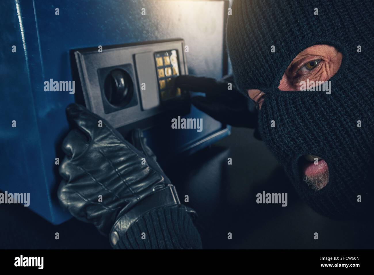 Burglar tries to find the combination code of a safe Stock Photo - Alamy