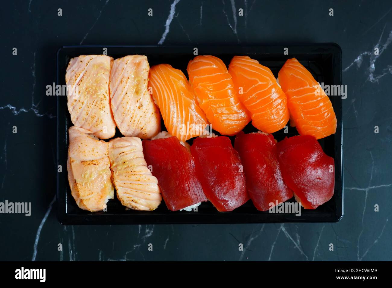 Sushi box with nigiri sushi: Aburi sake, sake and maguro Stock Photo ...