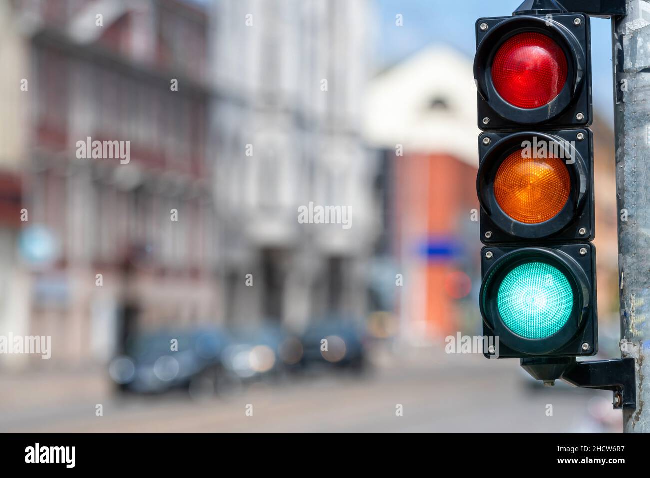 close-up of small traffic semaphore with green light against the ...