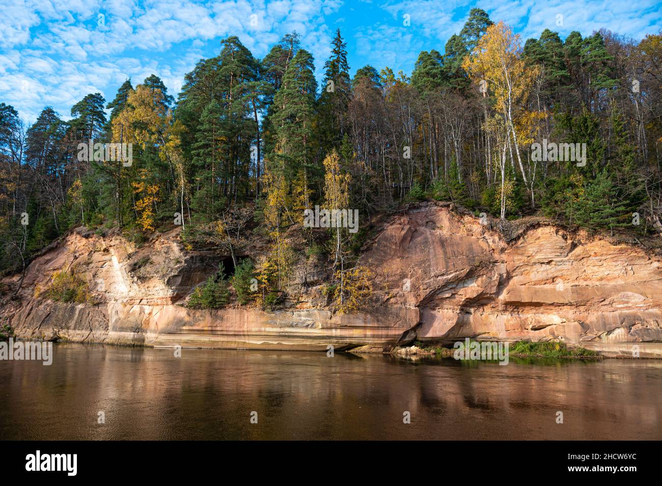 Devils rock and cave by the shores of the River Gauja, surrounded by a ...