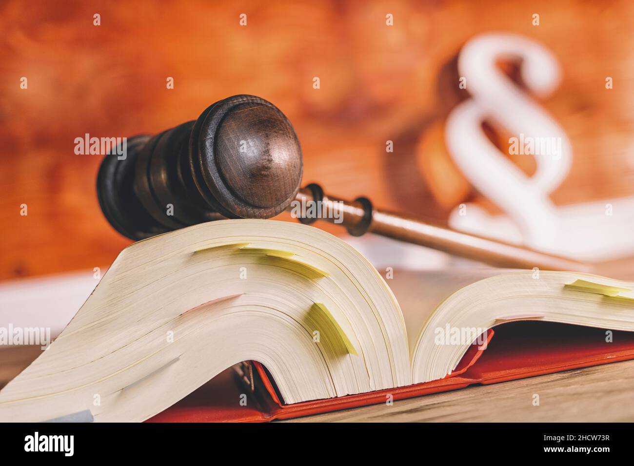 law book with gavel and paragraph symbol in court office - law concept ...