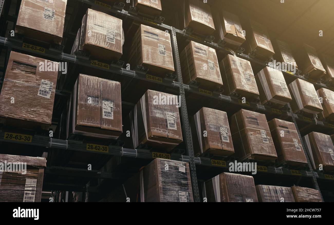 Huge distribution warehouse with boxes on high shelves Stock Photo - Alamy