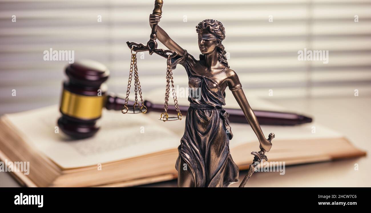 justice Statue with gavel on a open law book Stock Photo - Alamy