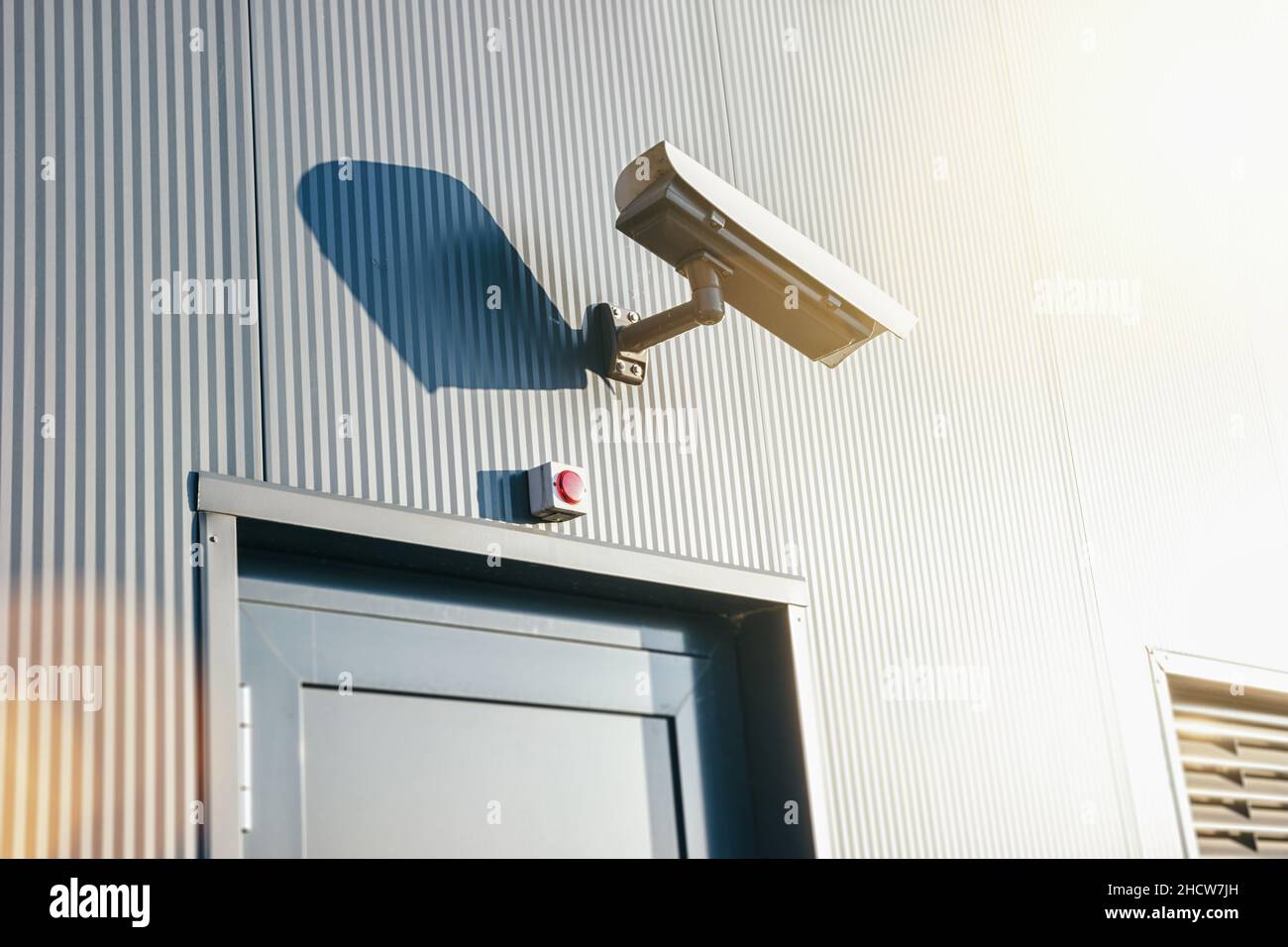 Security camera on a industrial building entrance door Stock Photo - Alamy