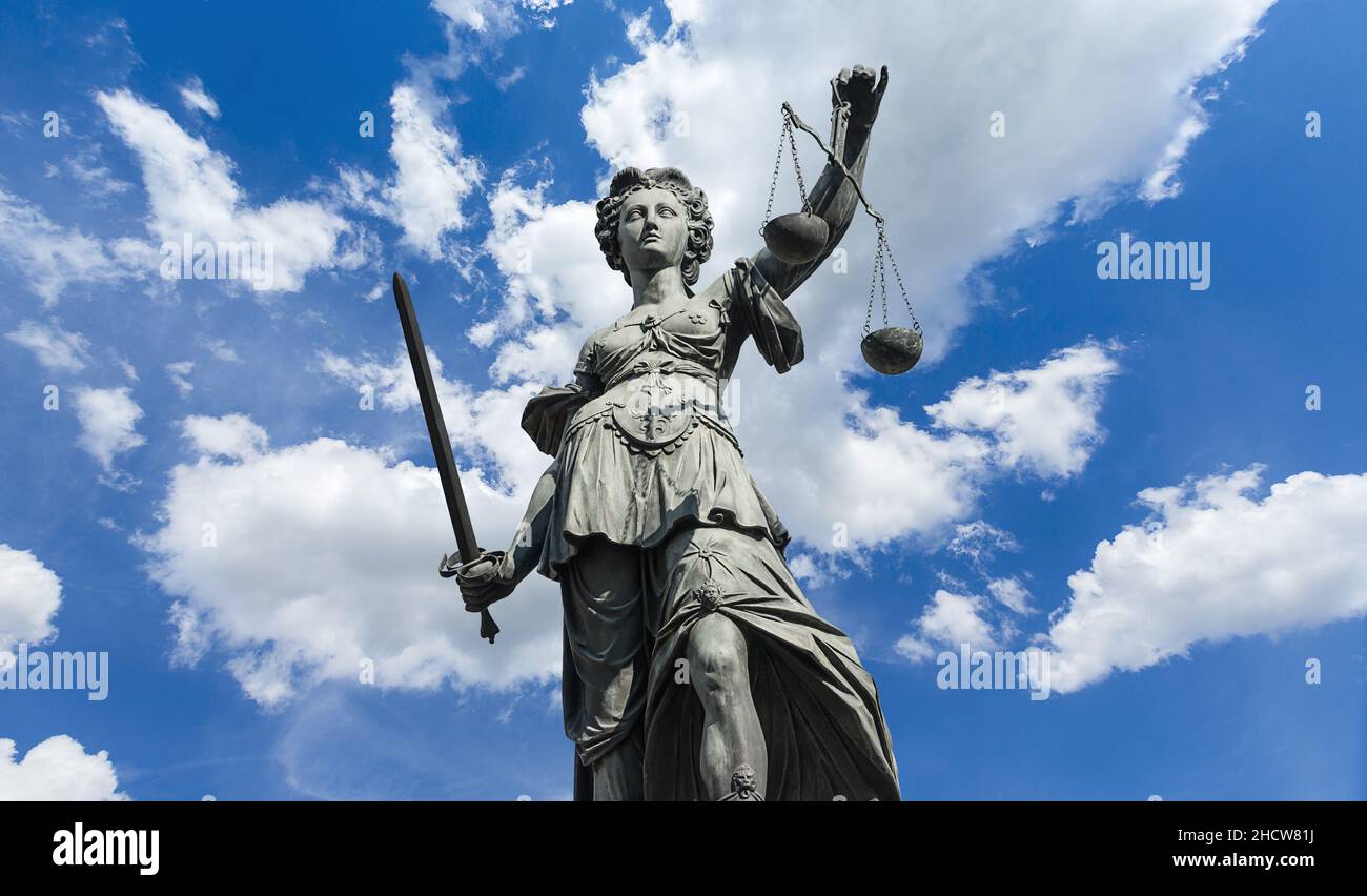 Statue of Justitia (justice goddess) on cloudy blue sky Stock Photo - Alamy