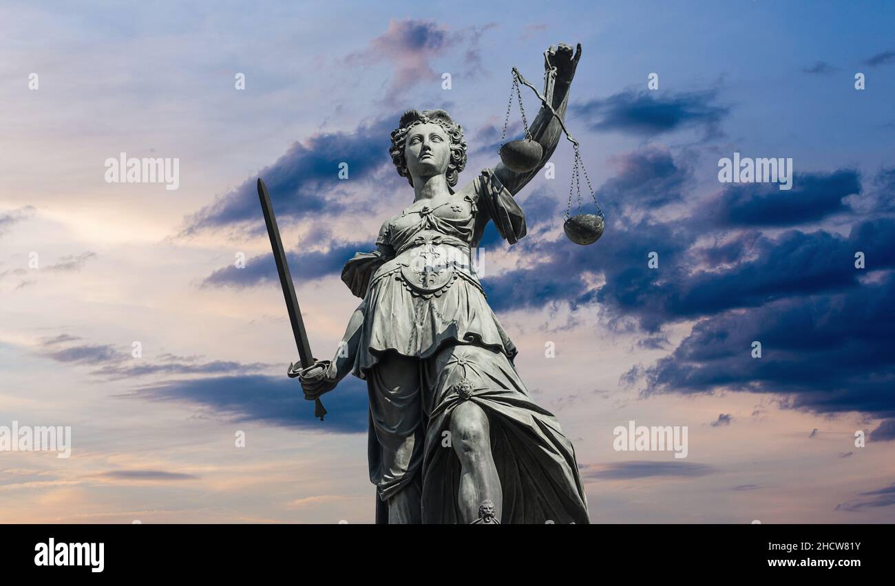 Justitia lady statue with cloudy sunset sky Stock Photo - Alamy