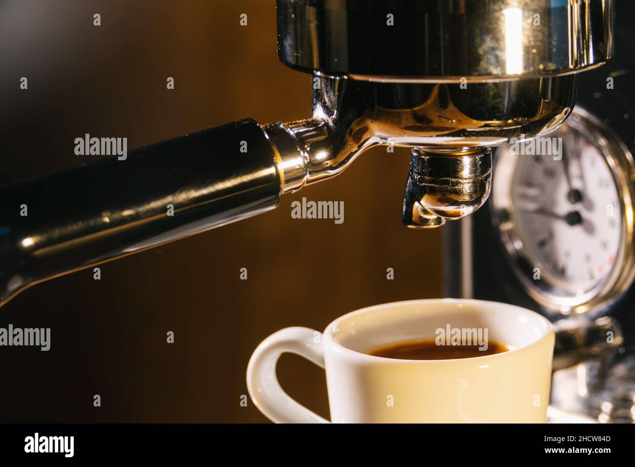 espresso pouring from coffee machine in to a cup. Professional coffee ...