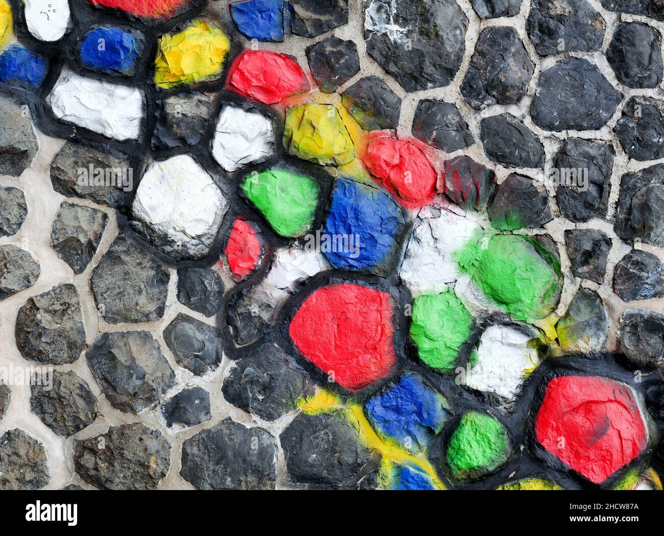 Stone wall with pattern.Individual stones of a stone wall are painted ...