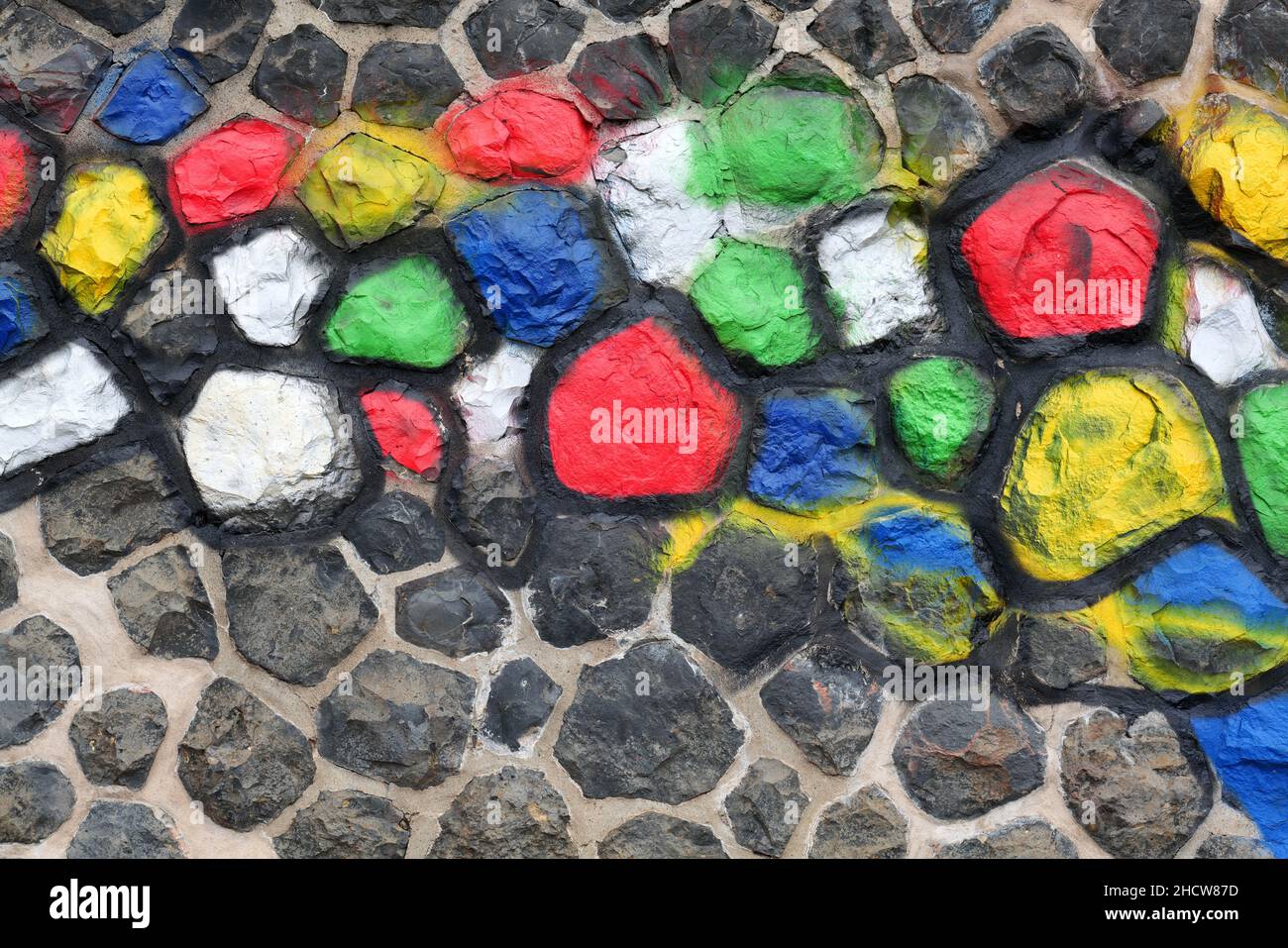 Stone wall with pattern.Individual stones of a stone wall are painted ...