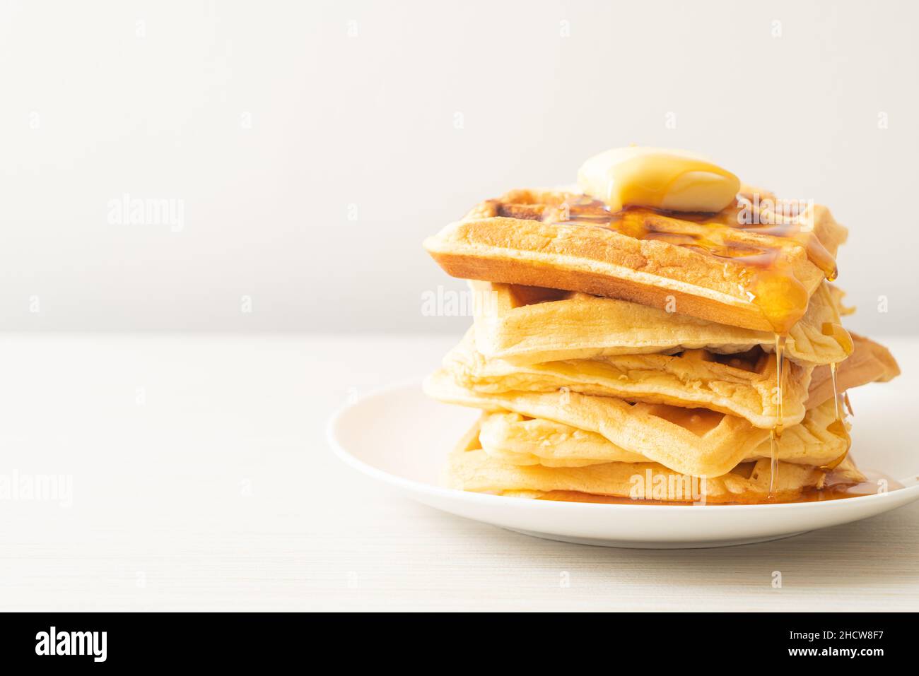 homemade waffle stack with butter and honey or maple syrup Stock Photo ...