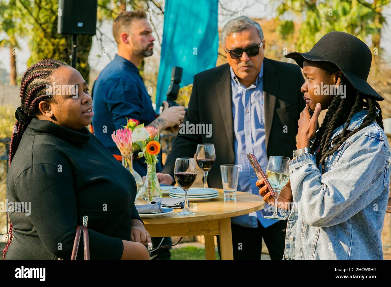 Group of VIP guests mingling and chatting at outdoor social event Stock ...