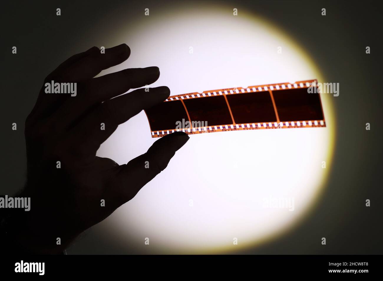 Hand holding 35mm film negatives Stock Photo - Alamy