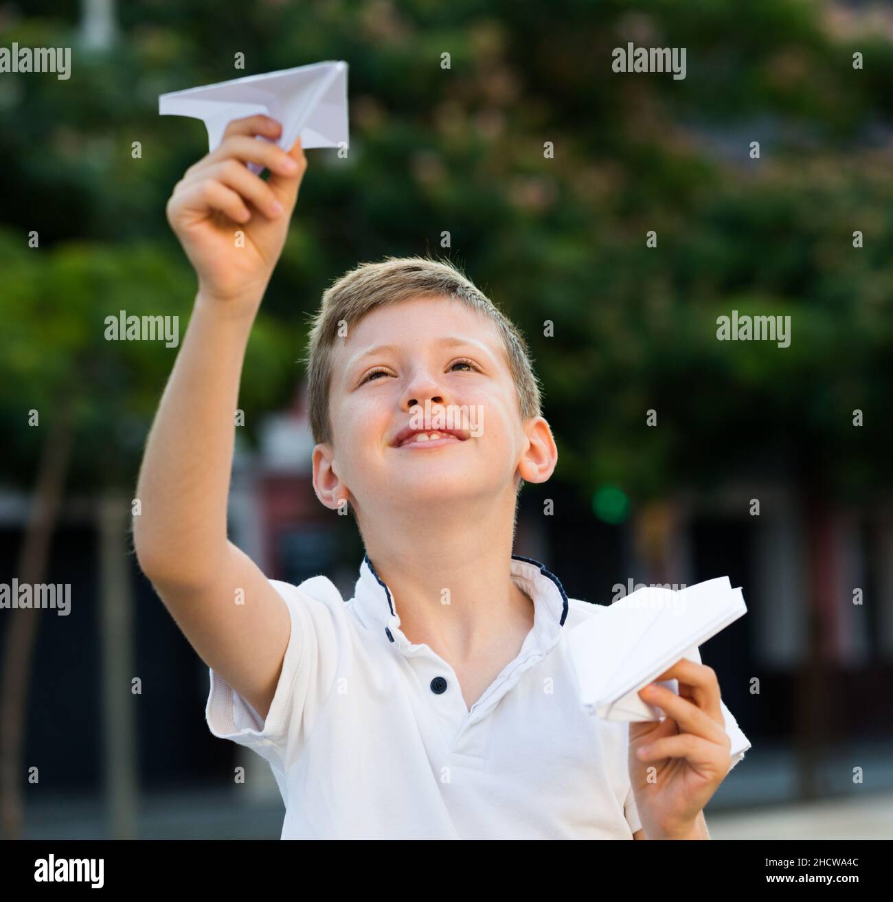 boy throwing paper plane Stock Photo - Alamy