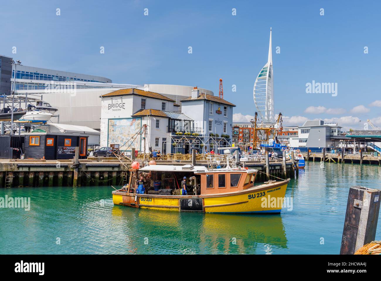 Small yellow fishing boat by the Fullers Bridge Tavern, Camber Quay and ...