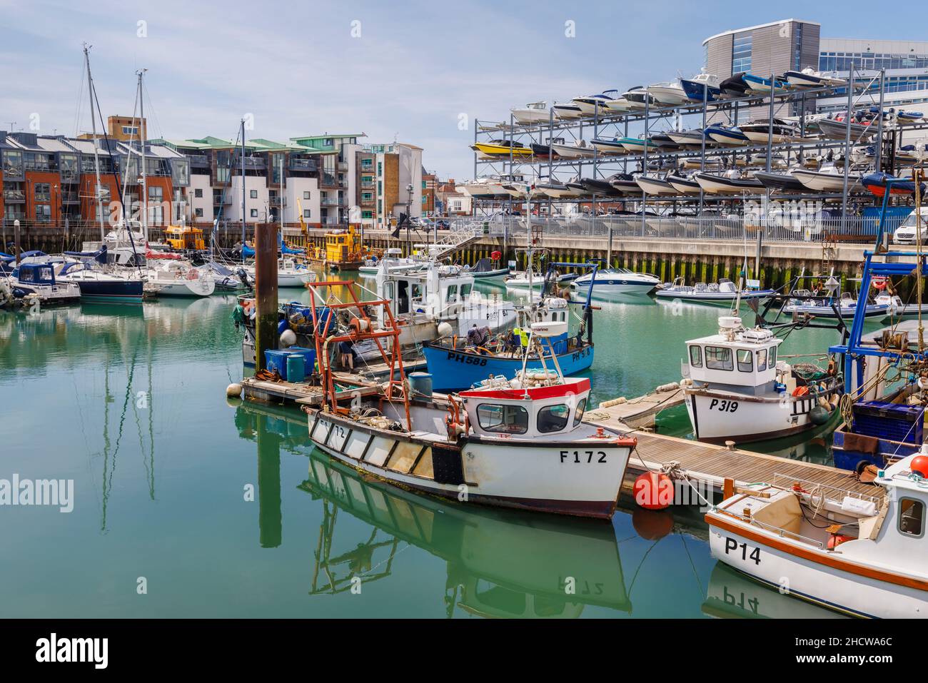 Dry stack and fishing boats moored in Camber Quay in Portsmouth Harbour ...