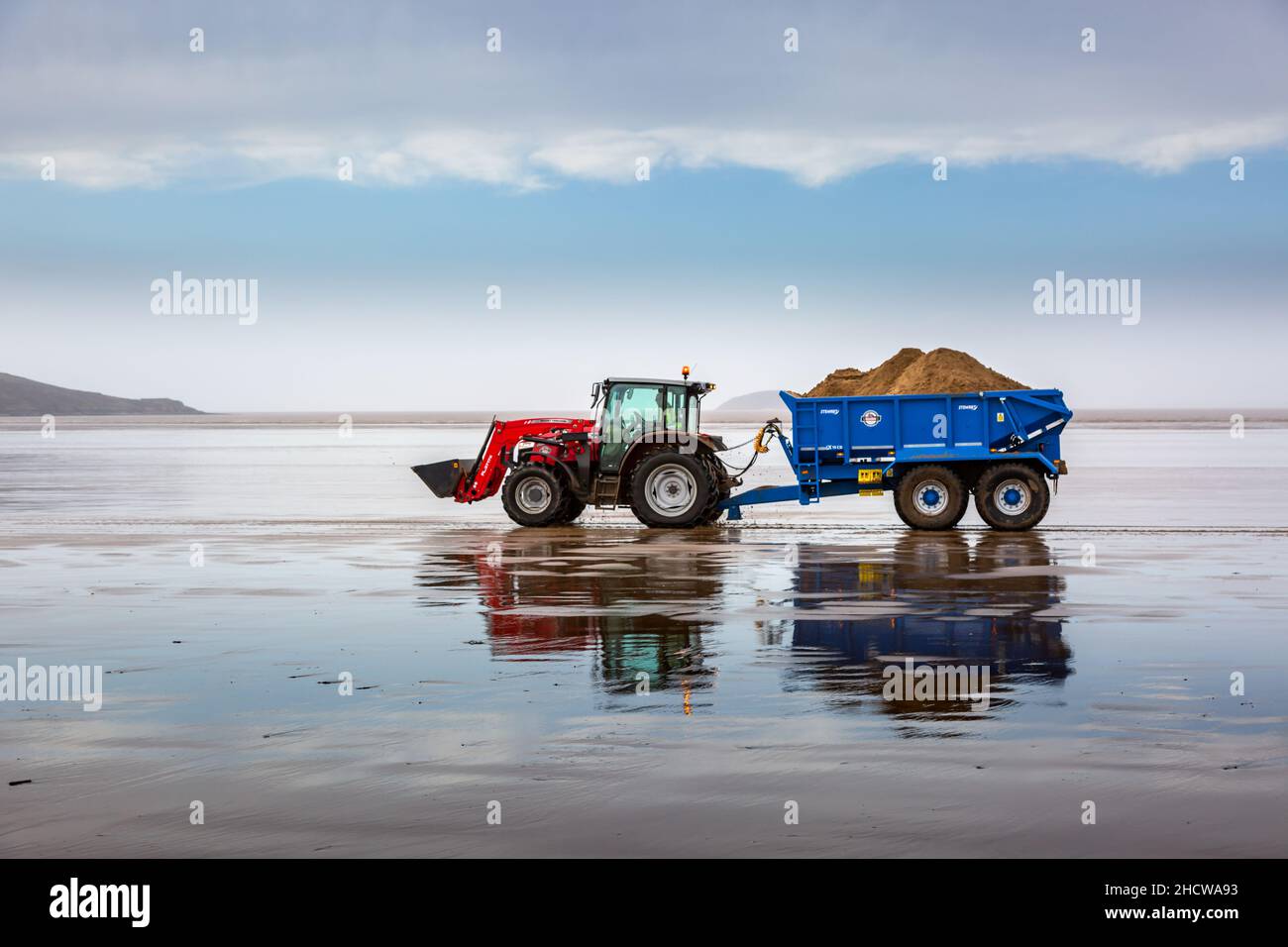 Tractor transporting sand from one part of the beach to another, West ...