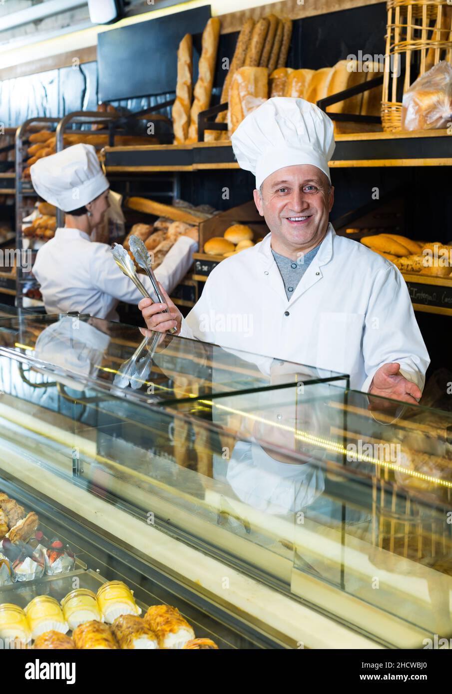 two bakers at the counter at bakery Stock Photo - Alamy