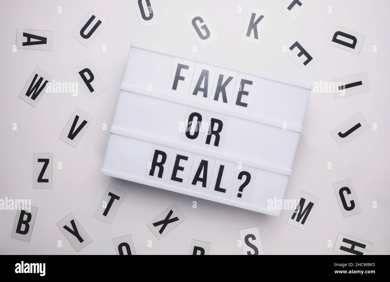 Fake or real displayed on a vintage lightbox, concept image Stock Photo ...