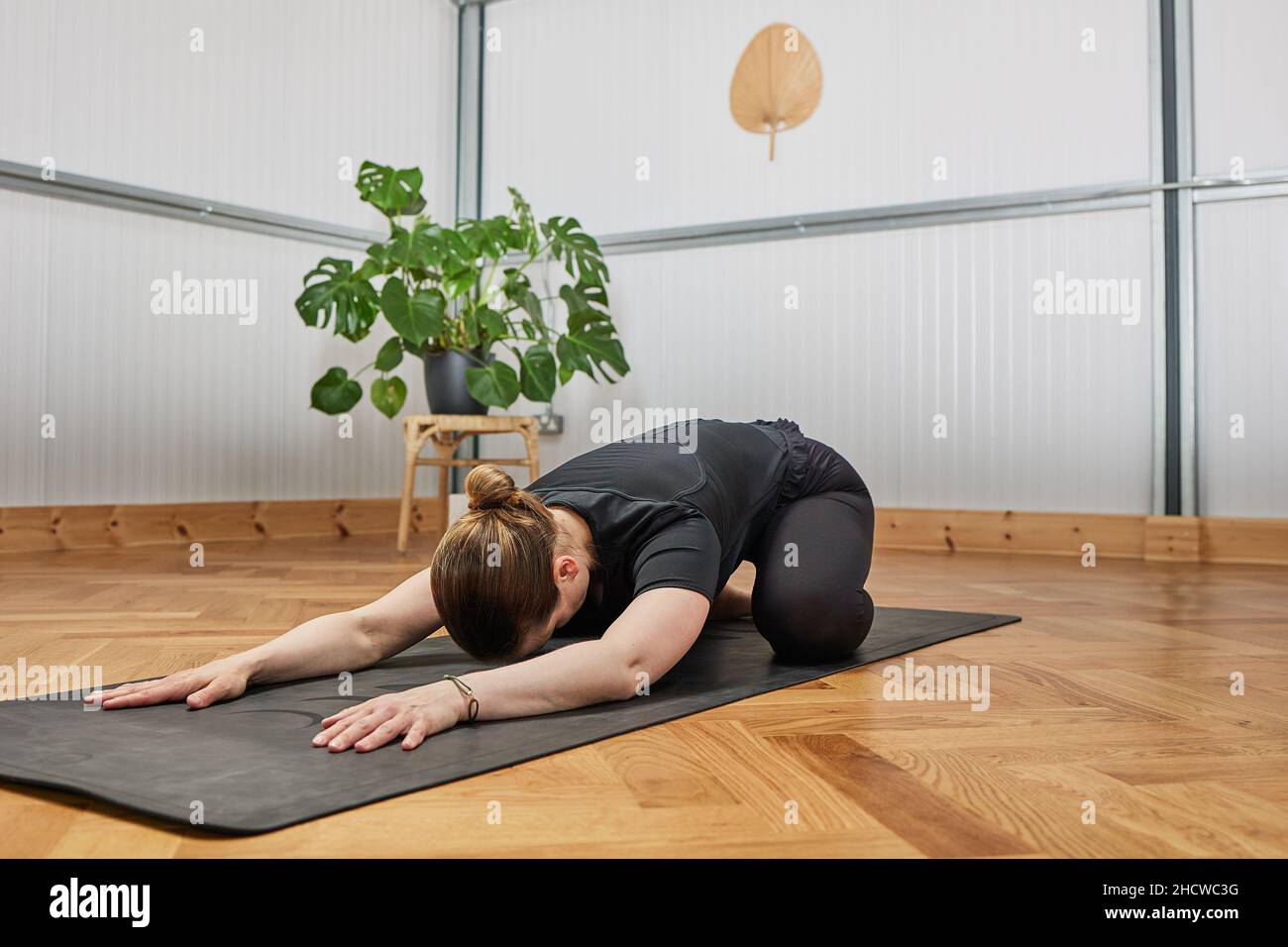 Caucasian woman performing stretches on a mat. mindfulness concept ...