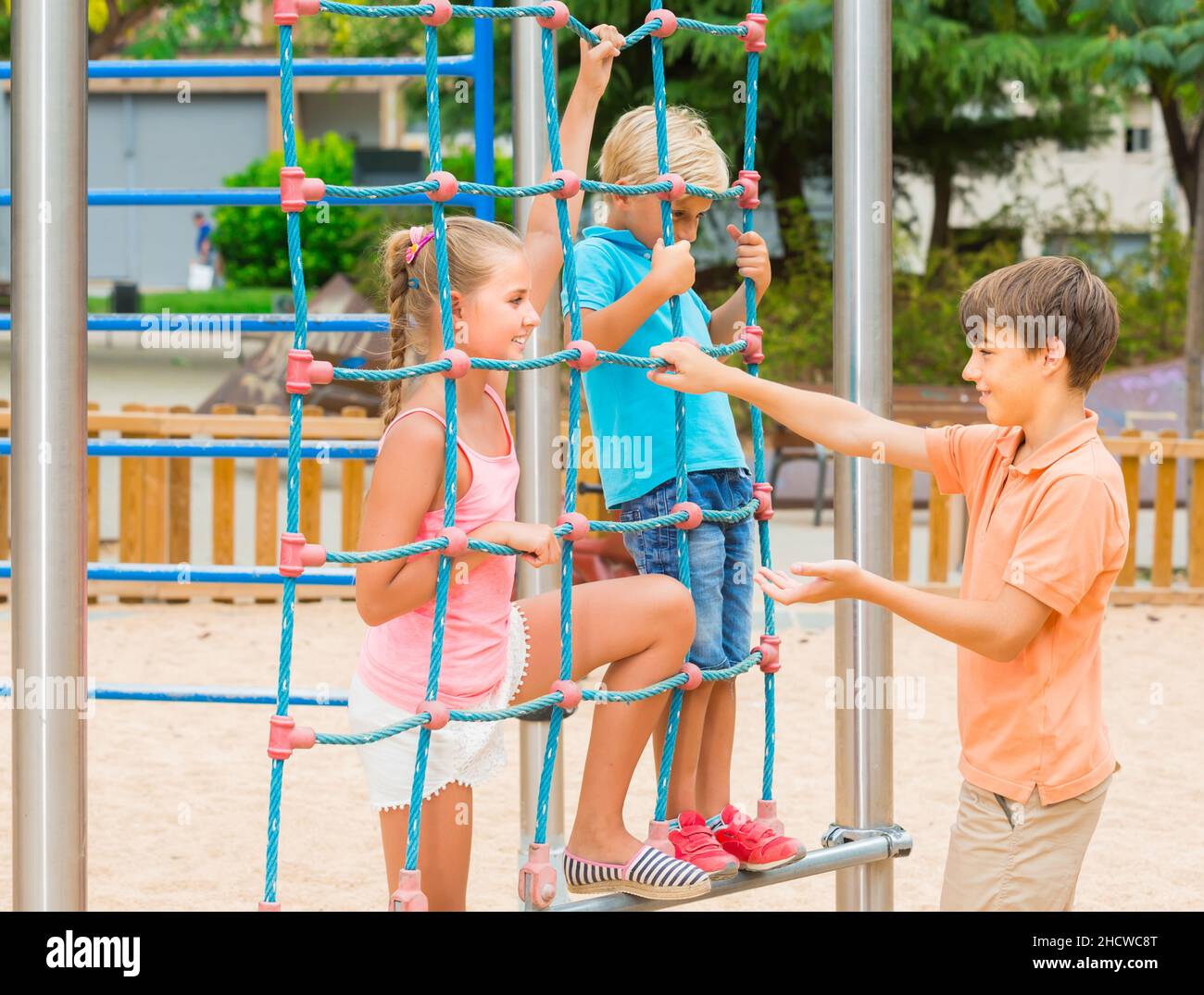children are climbing on the grid on the playground Stock Photo - Alamy