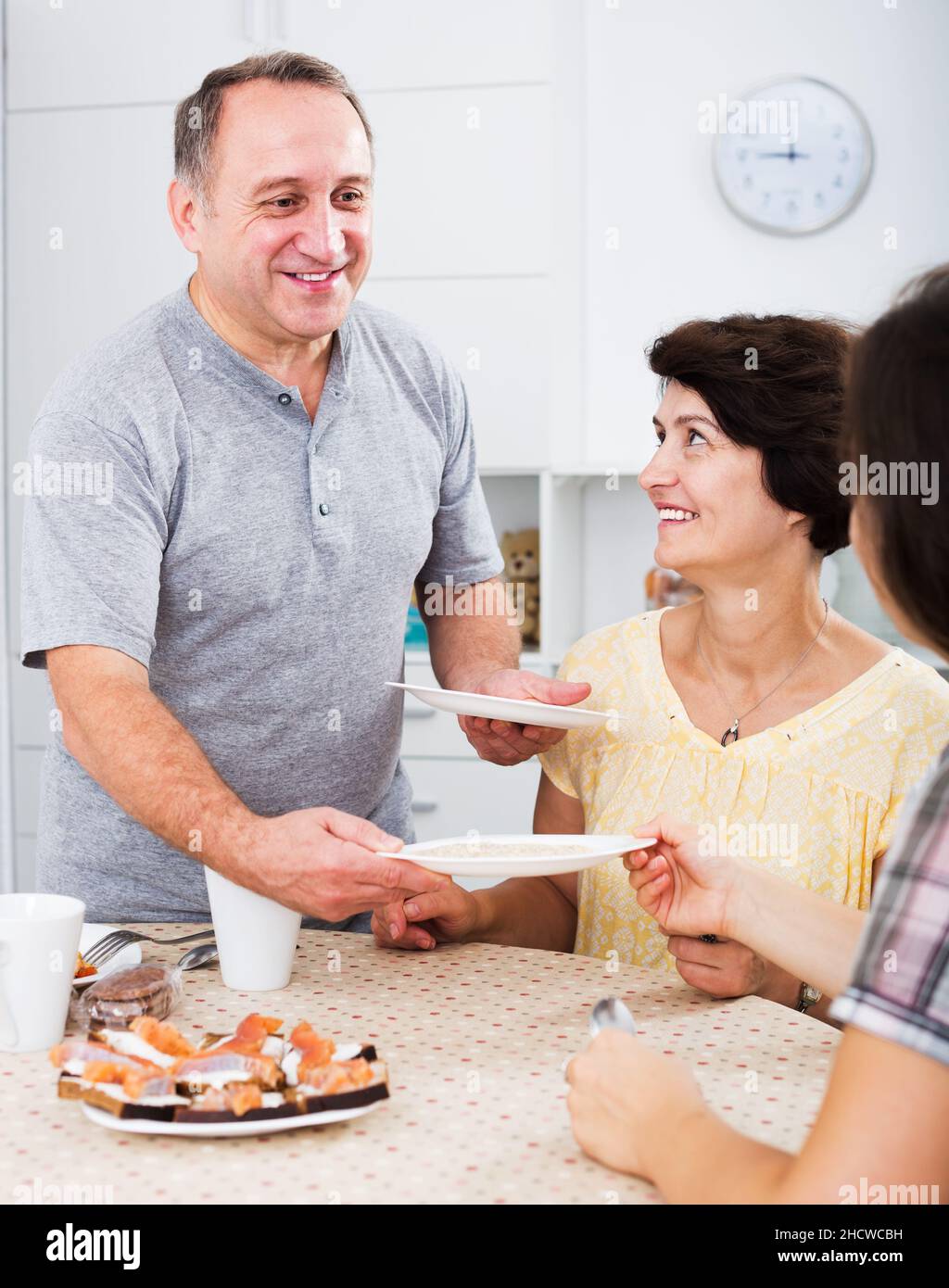 Man setting table for lunch Stock Photo - Alamy