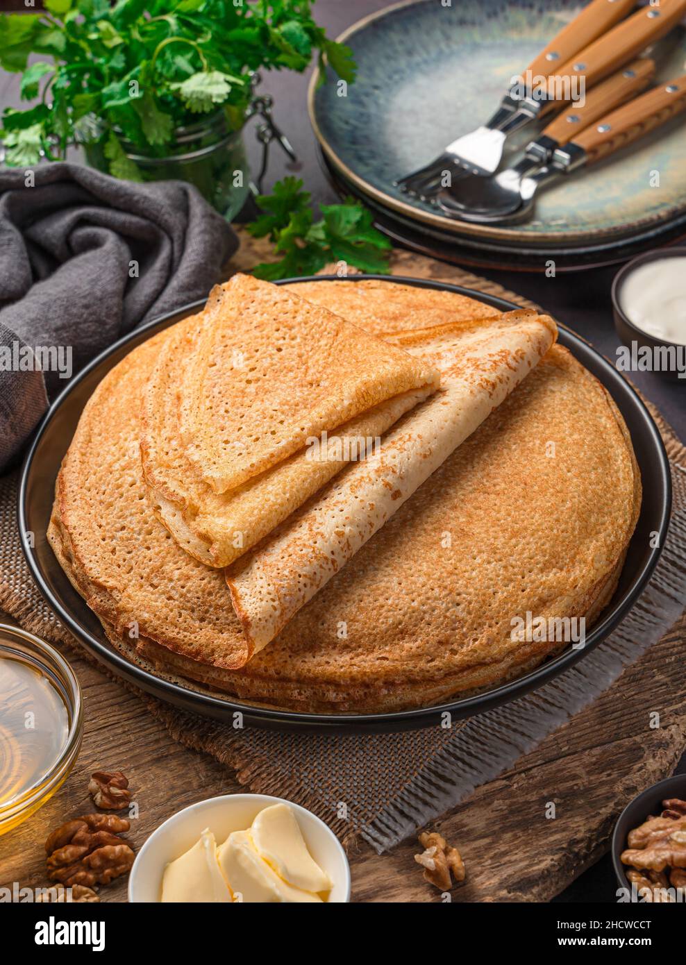 A stack of fried pancakes on a dark background. Maslenitsa, traditional ...