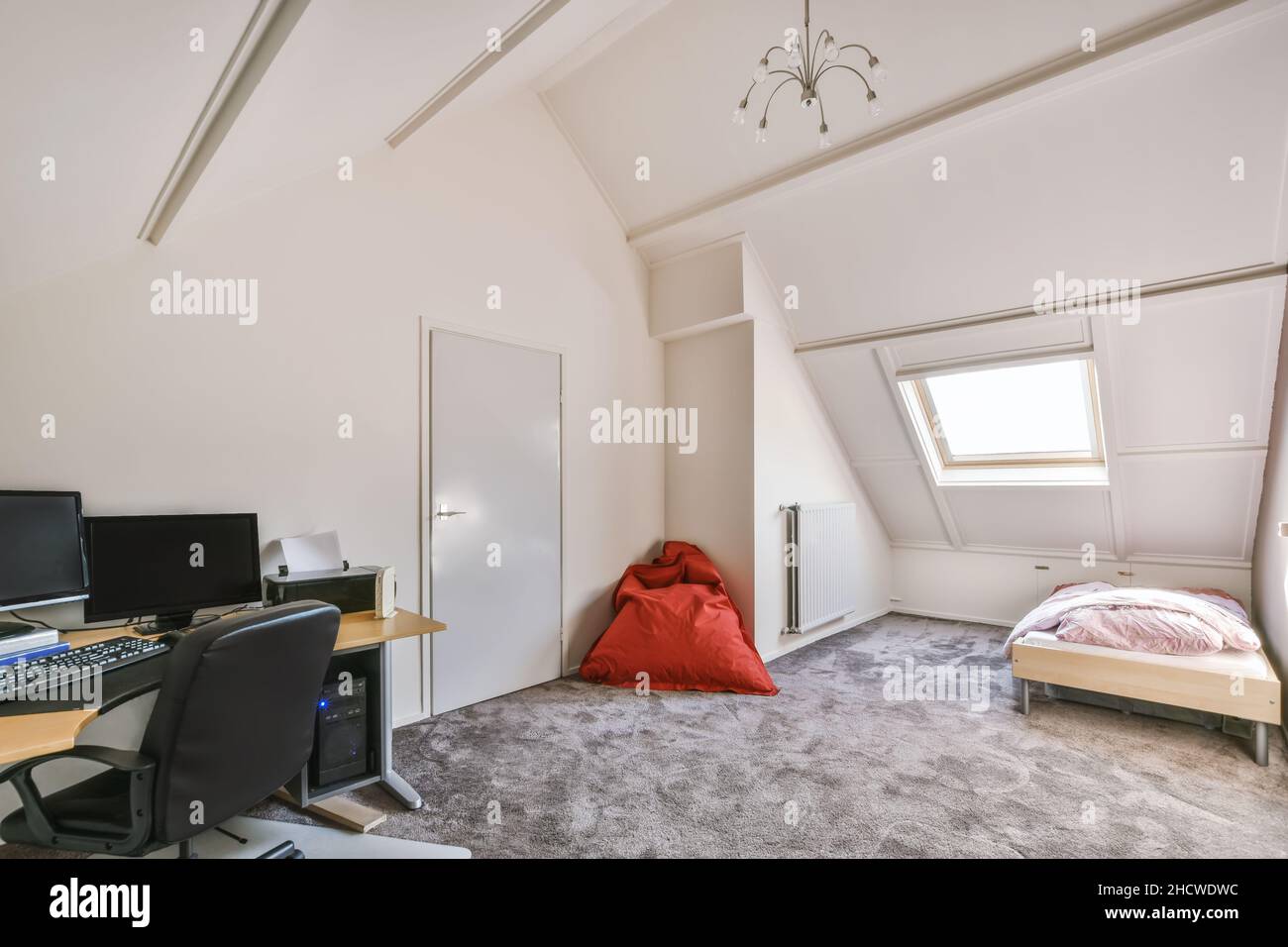 single room with bed, computer and work area Stock Photo - Alamy