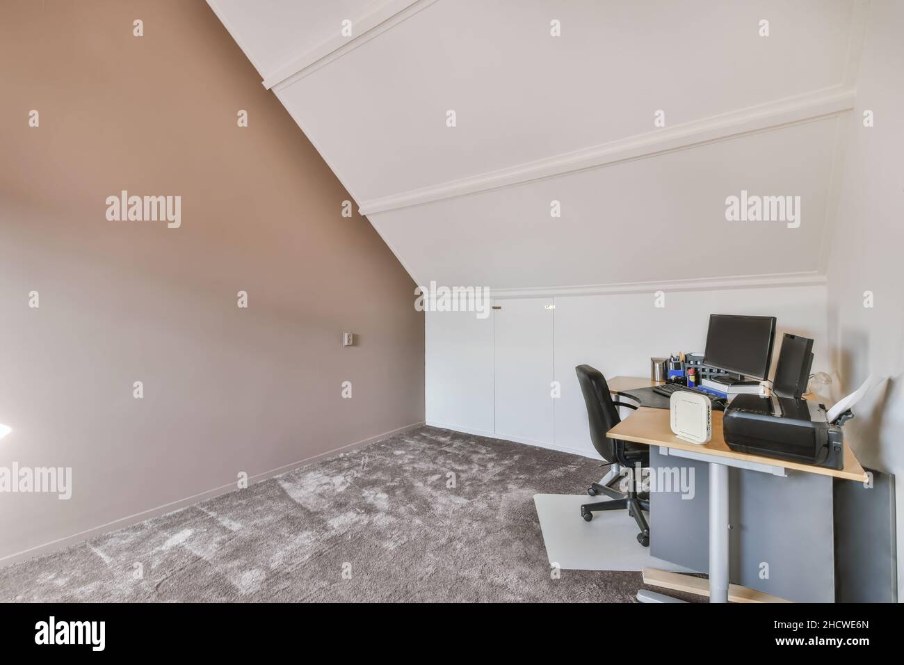 single room with bed, computer and work area Stock Photo - Alamy