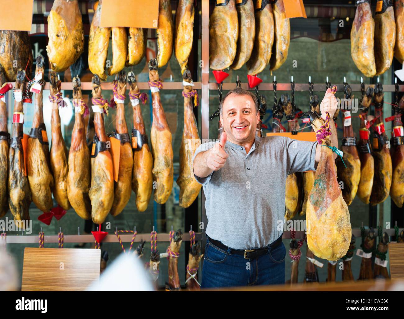 Customer buying iberico or serrano jamon leg Stock Photo - Alamy
