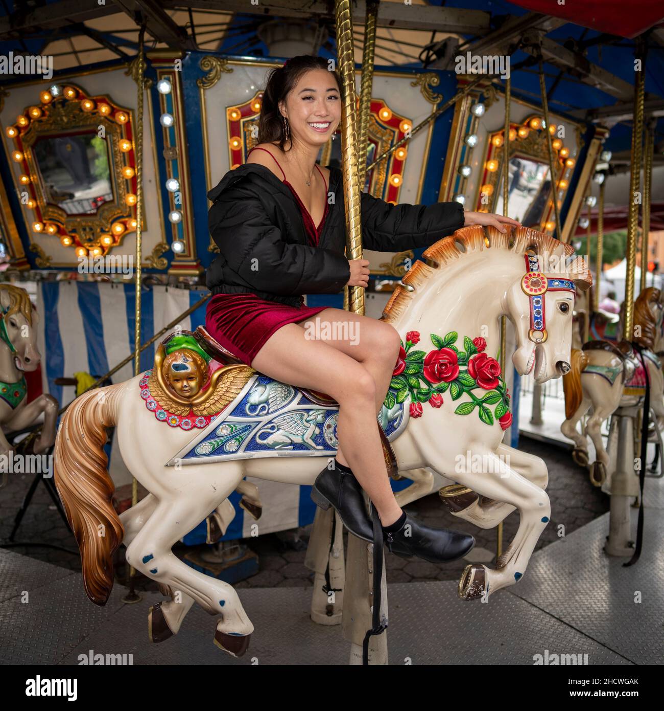 Young woman riding carousel hi-res stock photography and images - Alamy