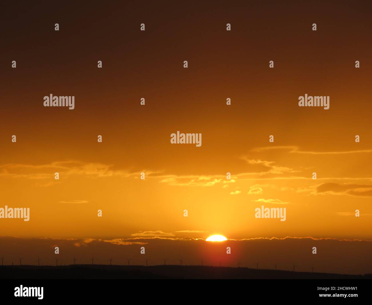 Beautiful orang sunset sky with the setting sun behind mountains and ...