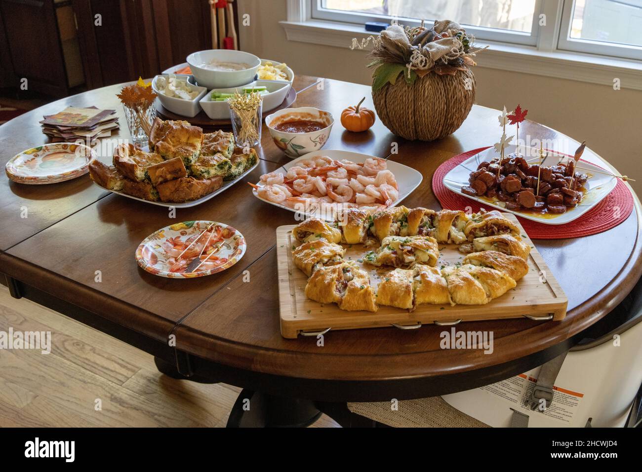 View of a wooden dining table with different types of dishes Stock ...