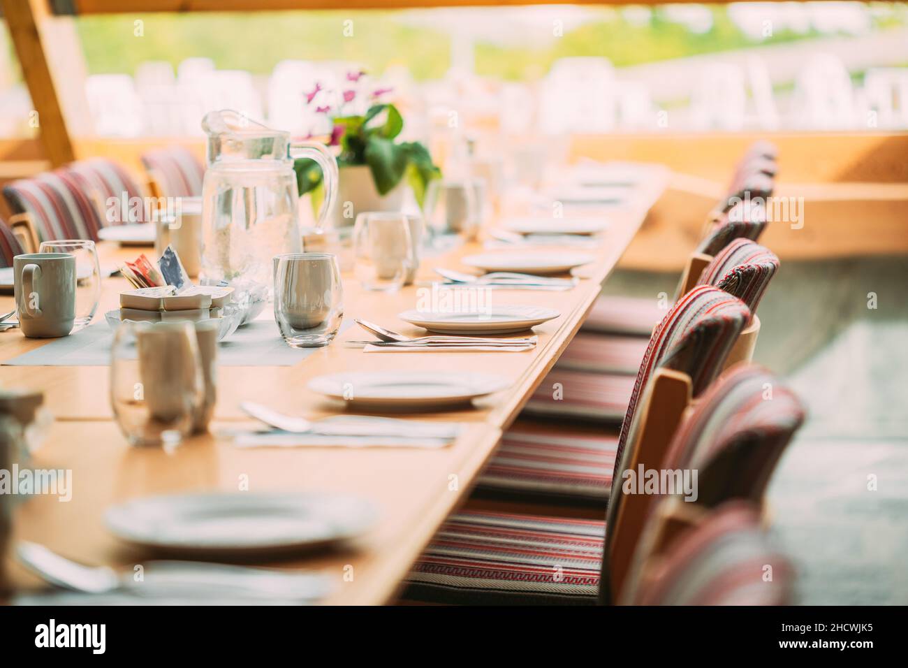 Cozy Interior Of Summer Cafe. Table And Cutlery Laid Out Stock Photo ...