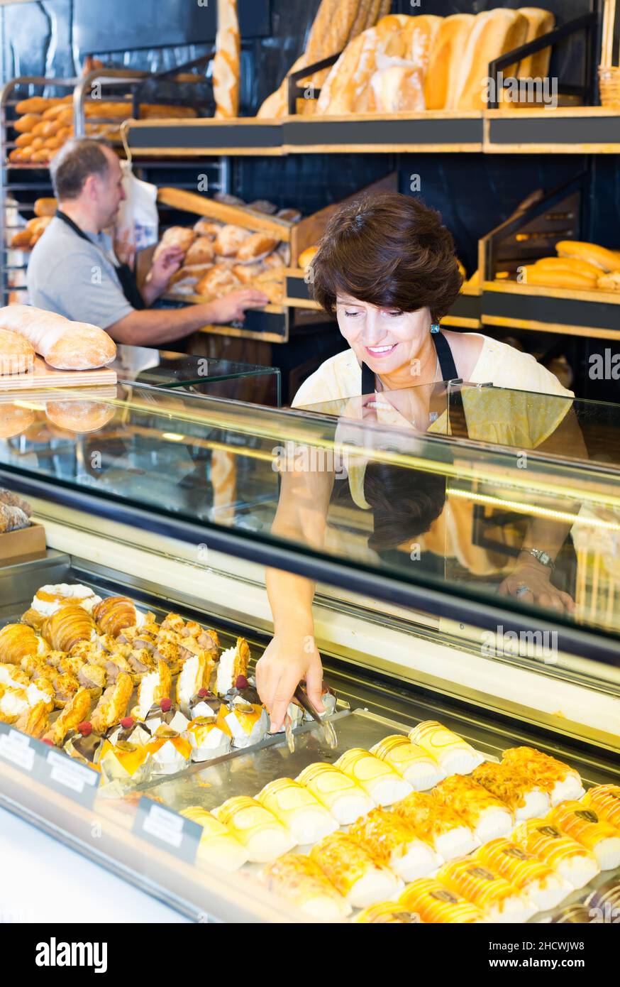 female baker offering fresh pastry Stock Photo - Alamy