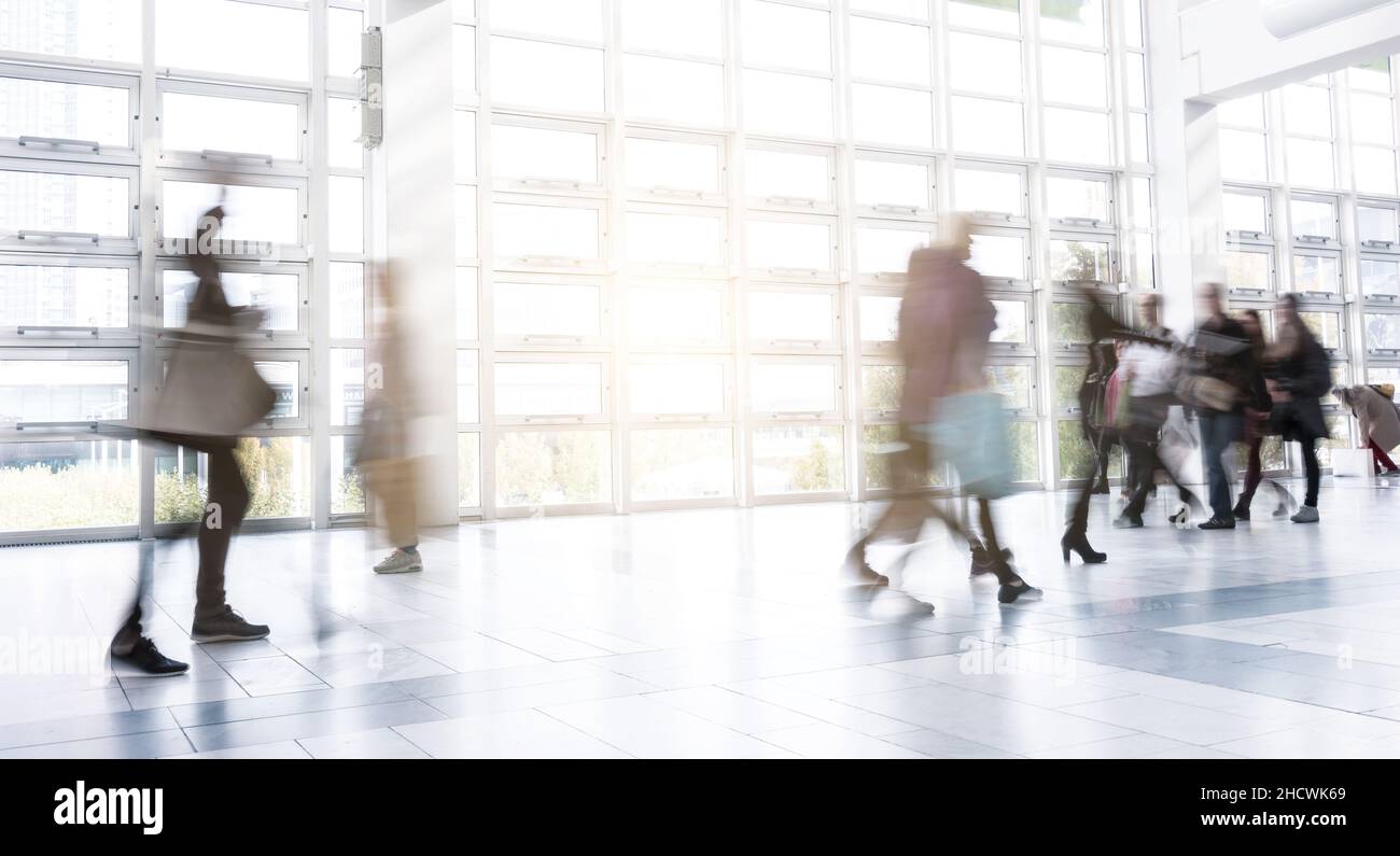 People Walking at a traid fair floor with motion blur Stock Photo - Alamy
